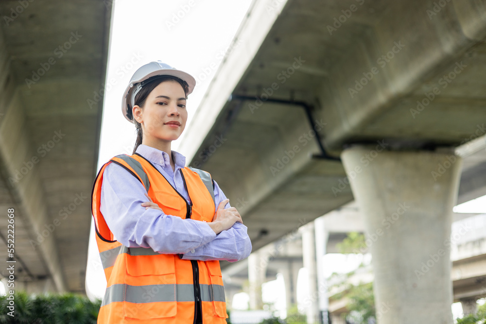Asian engineer worker woman or architect looking construction with ...