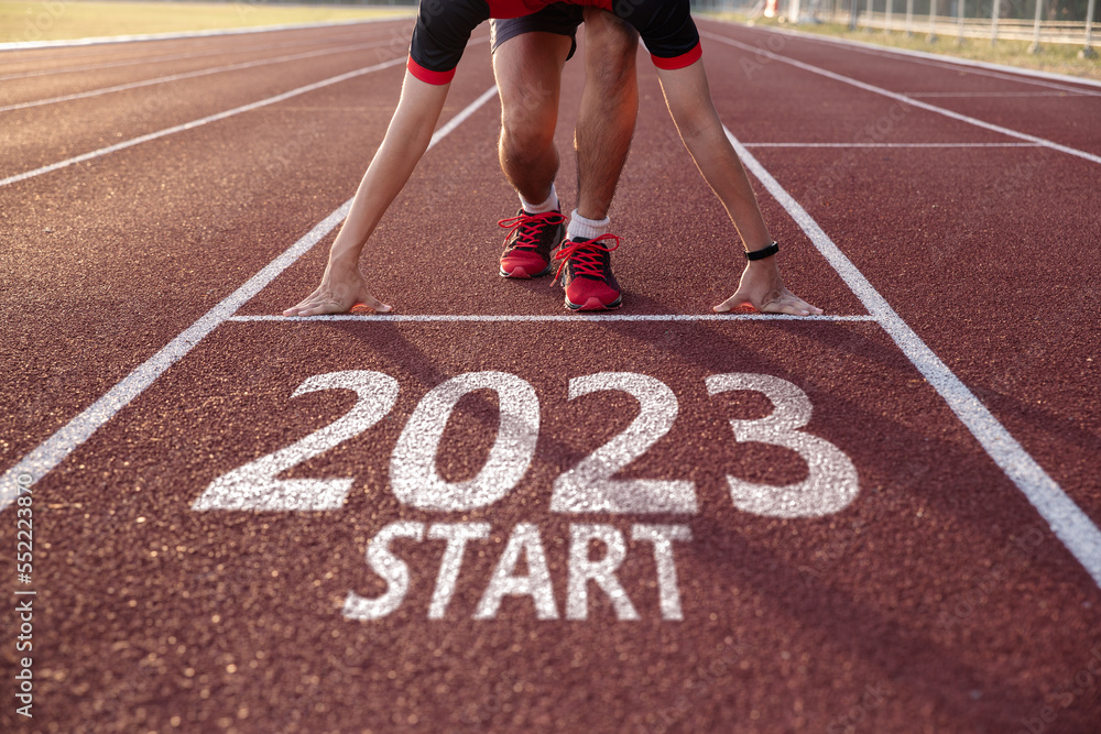 New year 2023 concept. Young man ready to run preparing for 2023 goals ...