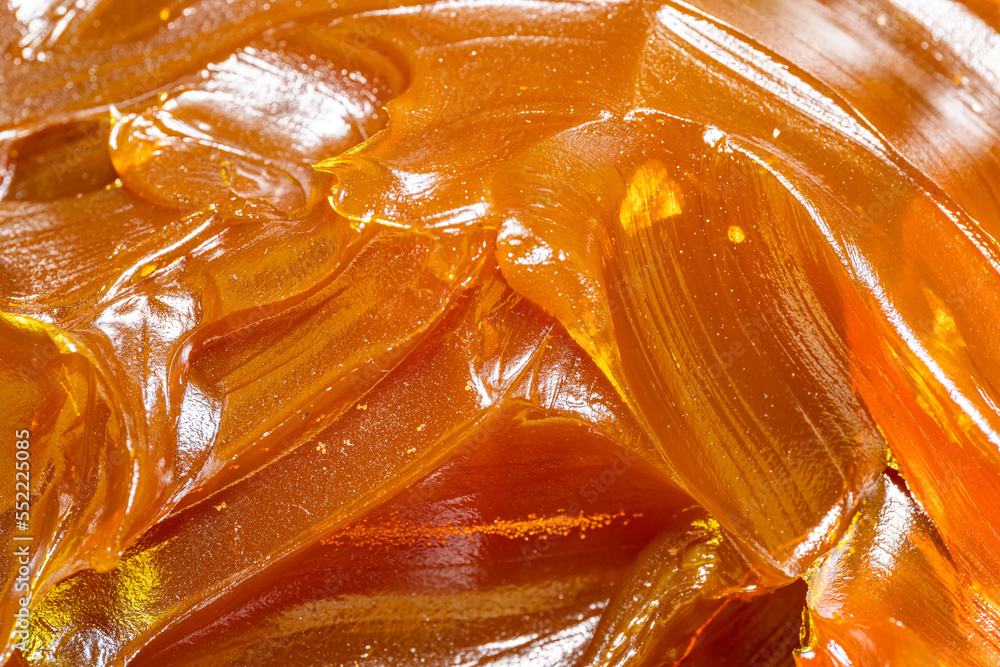 Close up of orange colored industrial grease. Rich and thick texture of ...