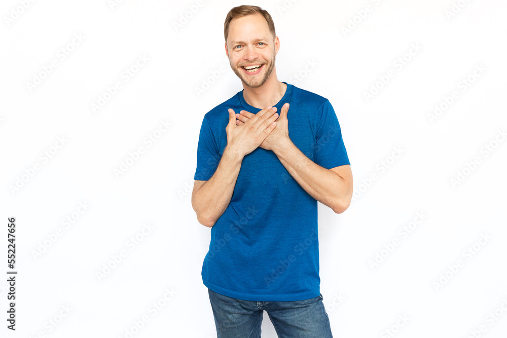 Cheerful man smiling at camera with his hands on chest. Caucasian man ...