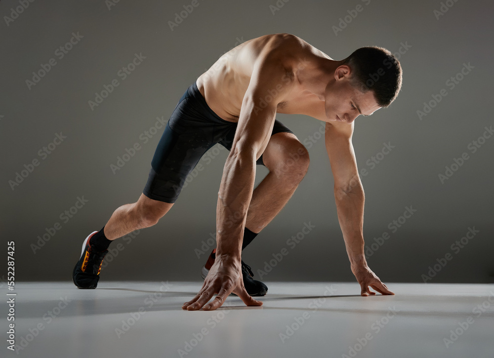 Sportive man, muscular athlete, runner wearing bicycle shorts in motion ...