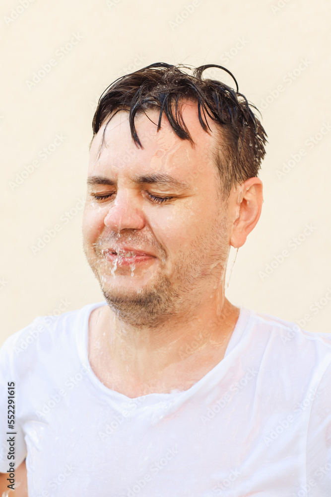 Young 32 years old european white male with closed eyes in water splash ...