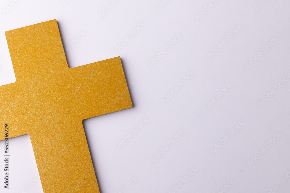 Overhead of yellow christian cross, on white background with copy space ...