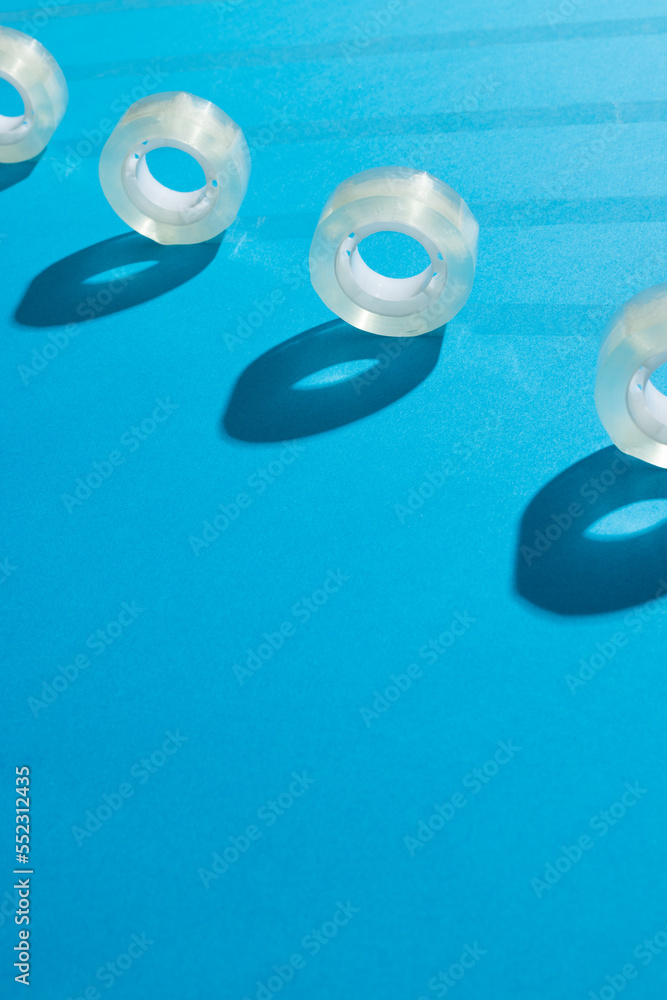 Rolls of transparent masking tape with copy space on blue background ...
