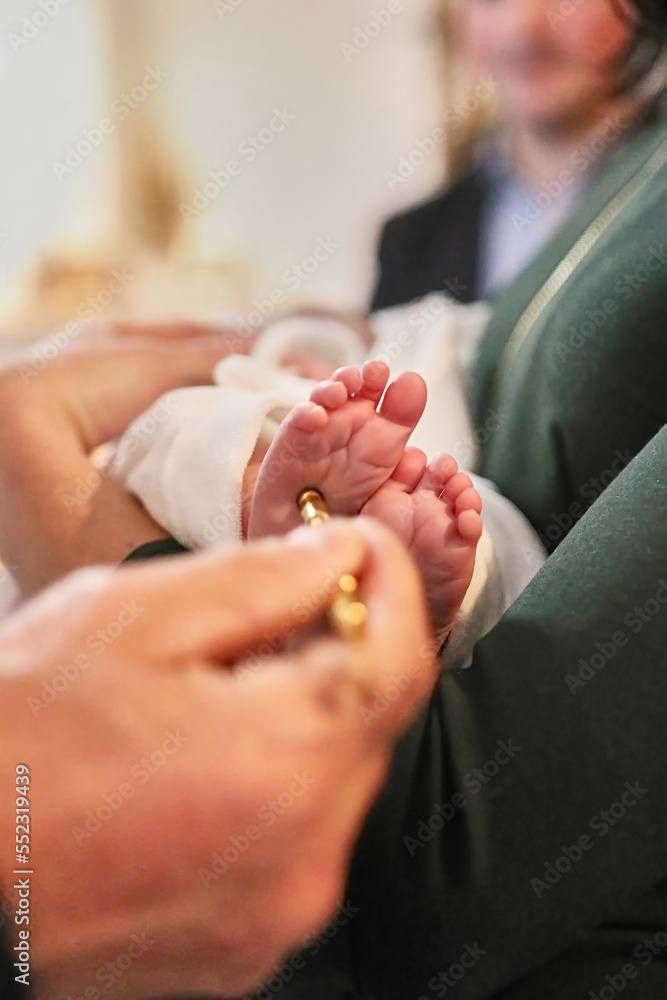 The priest performs the ceremony of anointing the feet of the newborn ...