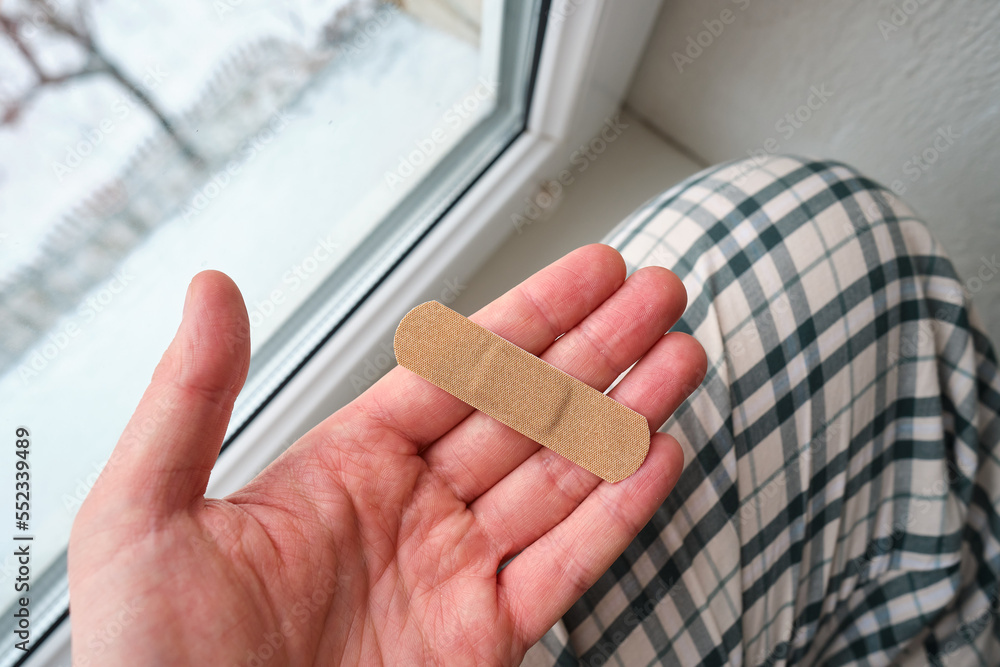 Male hand with a medical adhesive plaster close-up. Adhesive plaster on ...