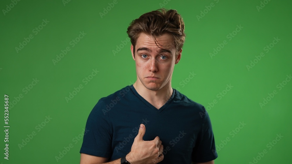 Confused young man 20s posing isolated on green screen background in ...