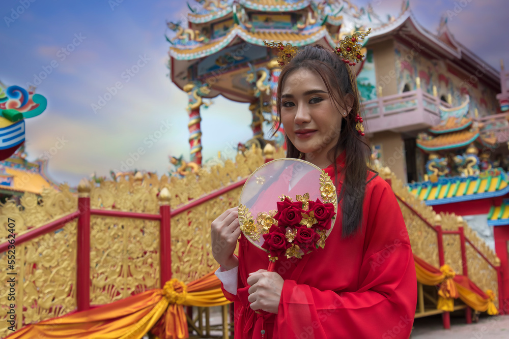Portrait woman in a Chinese costume with a sword in the forest. Chinese ...