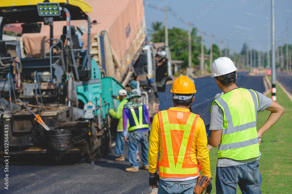 Asian architectural engineer working at road construction site For ...