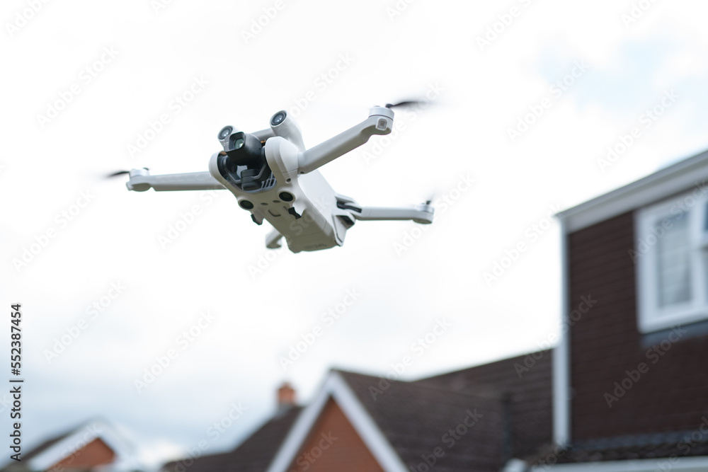 Consumer high-tech drone showing its gimbal camera while just about to ...
