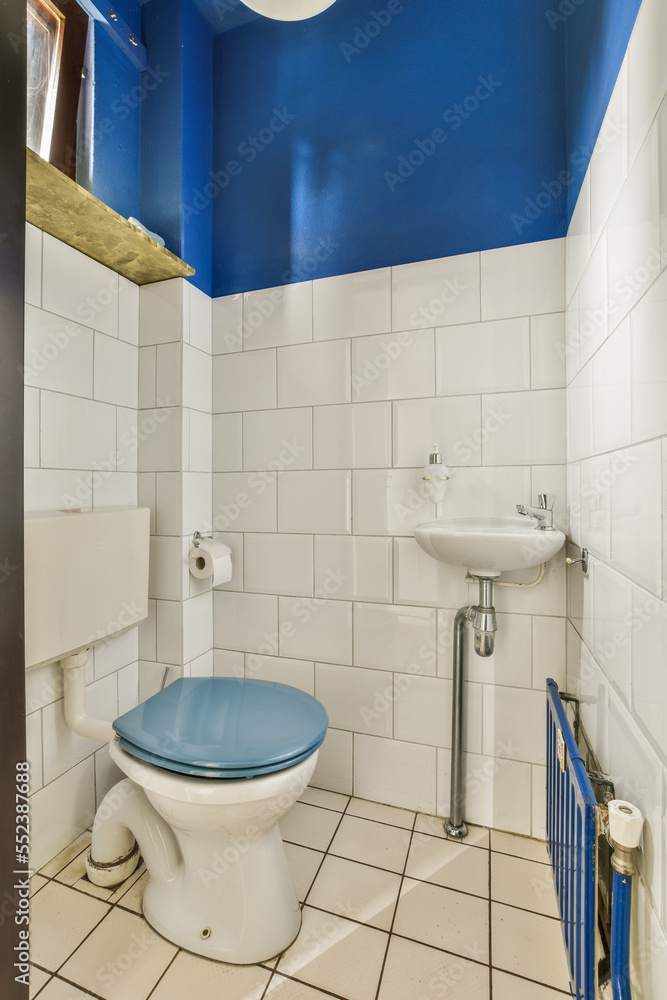 Flush toilet installed on beige wall and illuminated shelf in light ...