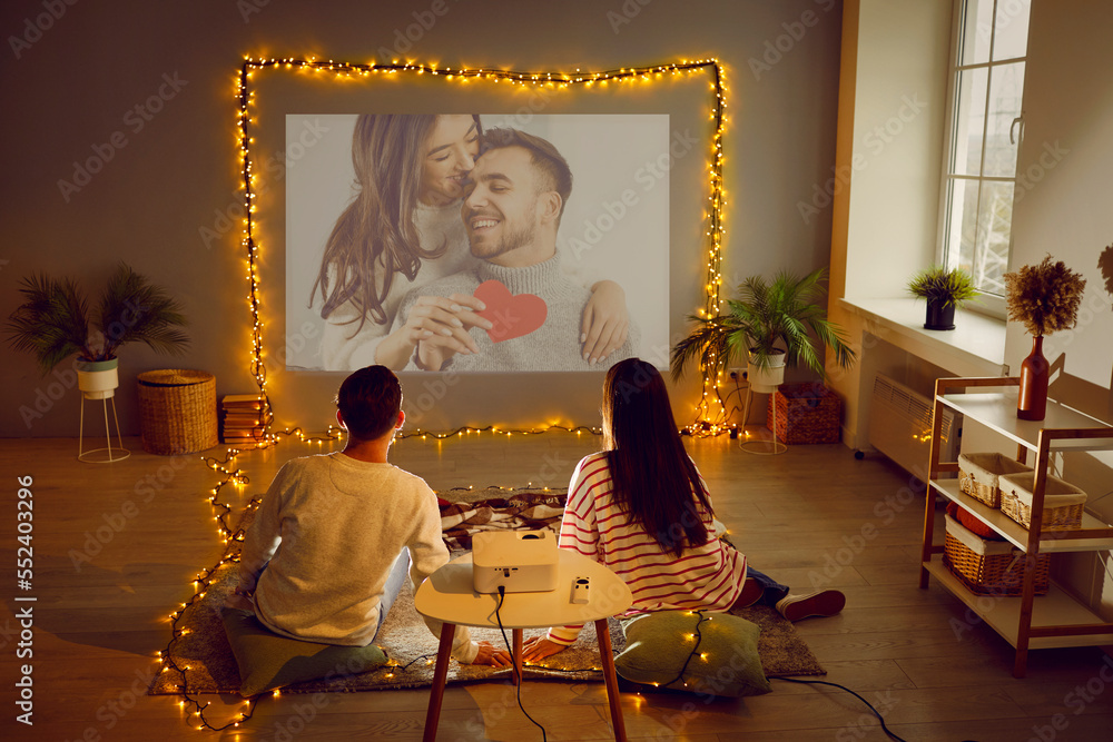 Romantic couple having Valentine's Day date at home, using modern ...