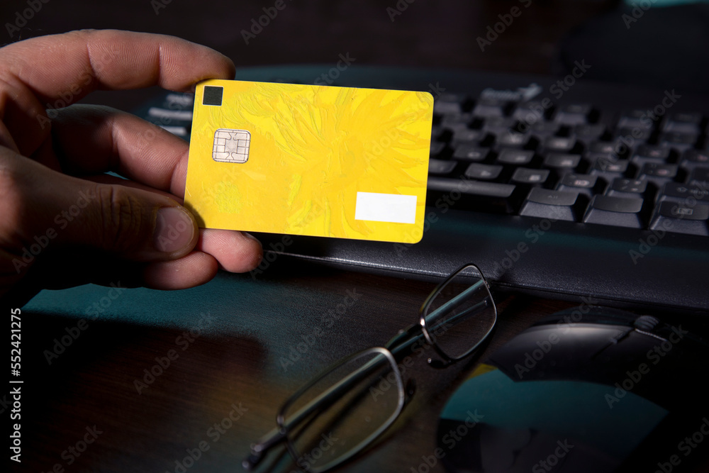 visa card in man hand keyboard background Stock Photo | Adobe Stock