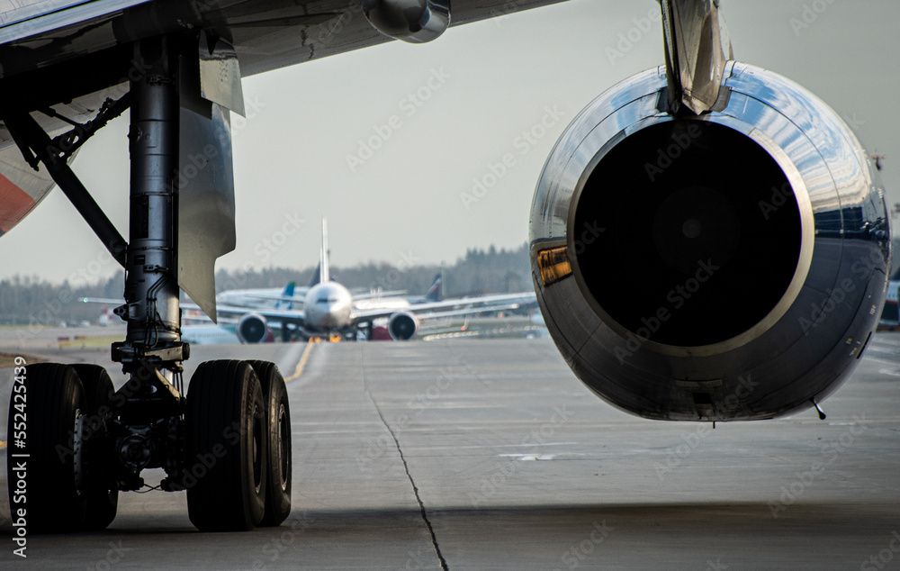 Jet engine under the wing of a modern passenger aircraft at an ...