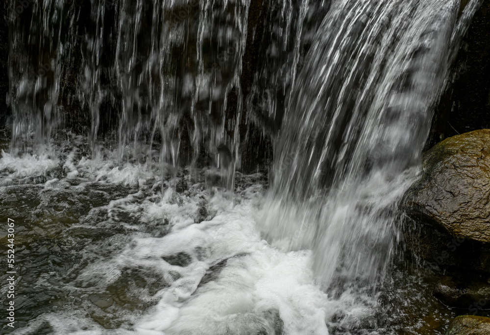 Foto de waterfall caused by forge in roadway do Stock | Adobe Stock