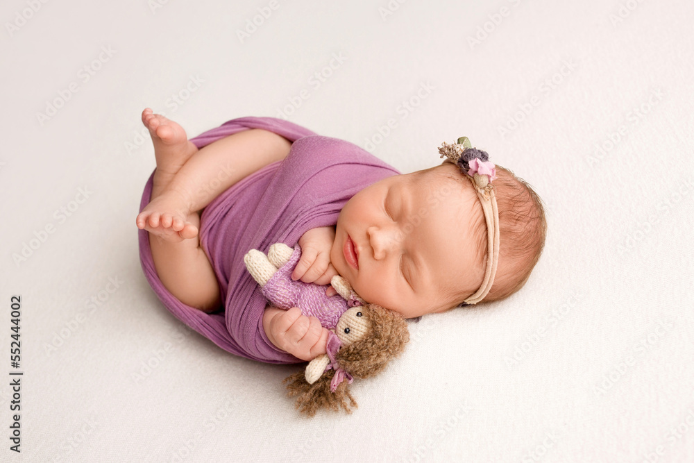 Sleeping newborn girl in the first days of life on a white background ...