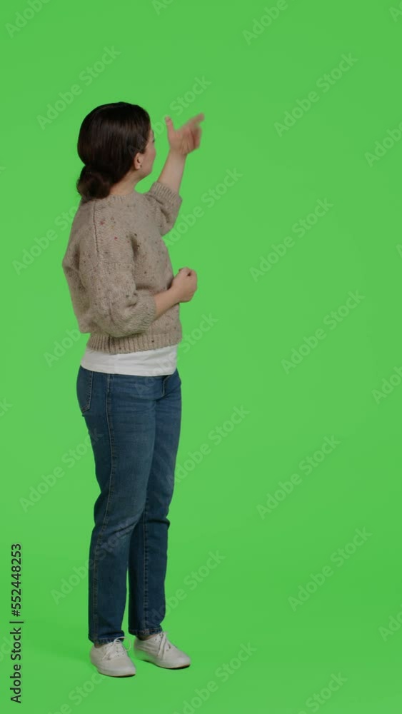 Vertical video: Side view of cheerful young adult pointing at ...