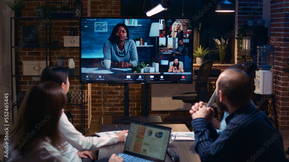 Business team remote meeting, coworkers videocall at night time ...