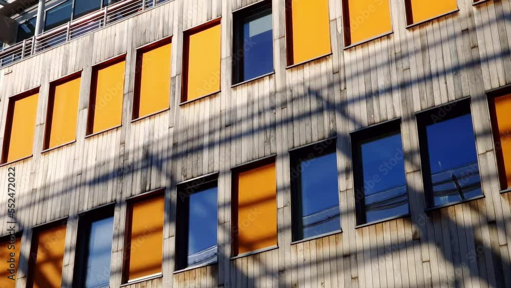 Orange window shades and timber cladding on the exterior wall, with ...