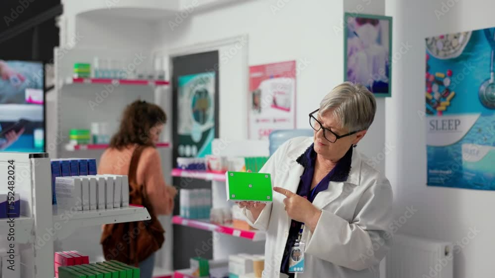 Pharmaceutical worker holding greenscreen on box of pills, female ...