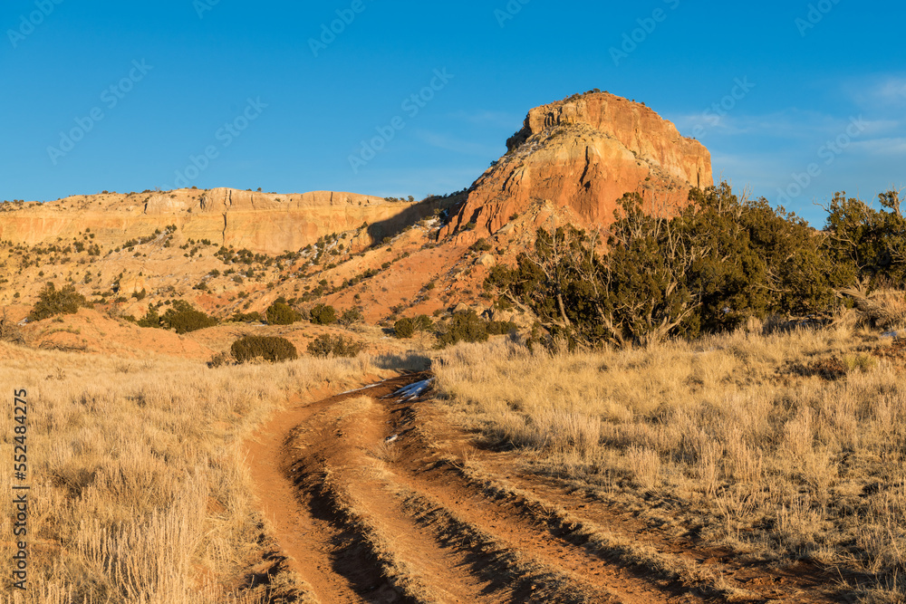 4wd dirt road curves toward a high desert mountain peak at Ghost Ranch near Santa Fe, New Mexico ...