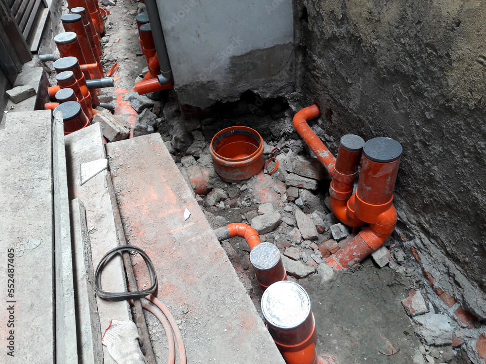 Home sewer sewage pipe construction. Newly installed ductwork. The ...