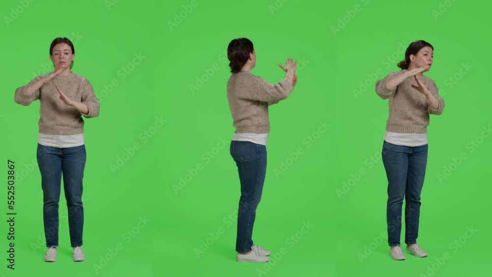 Full body of model doing t shape timout sign on green screen backdrop ...