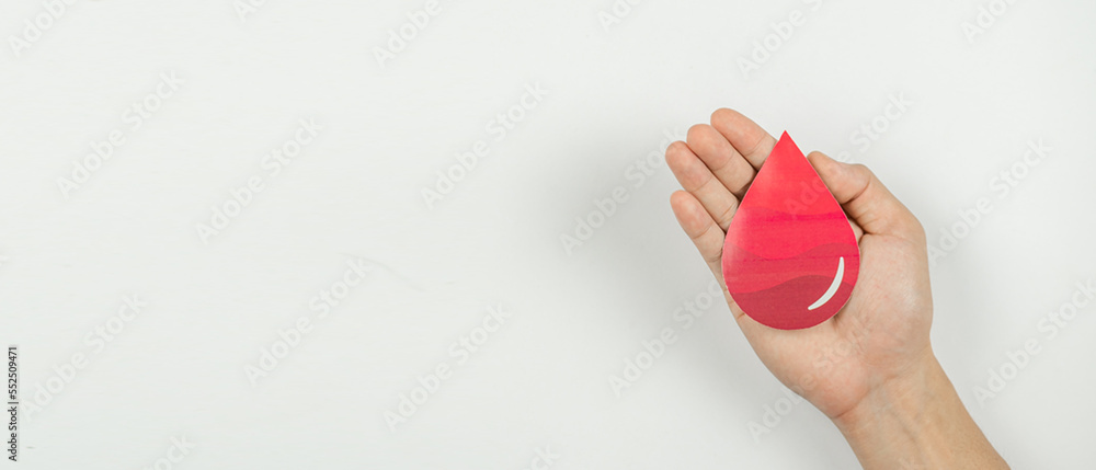 Poster Hands holding blood drop paper cut on white background, Blood ...