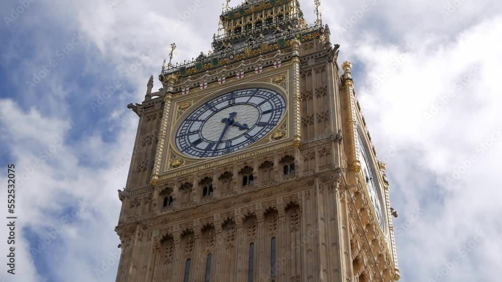 Low-angle shot of Big Ben clock tower after restoration as clouds pass ...