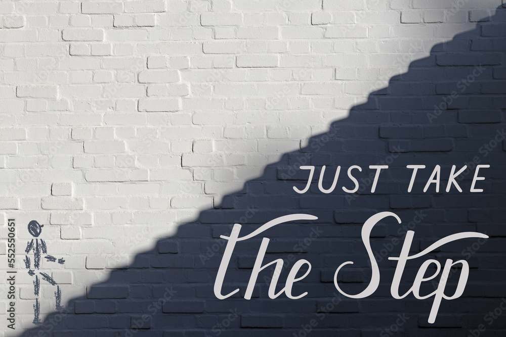 Just take the step - handwritten lettering on white brick wall, divided ...