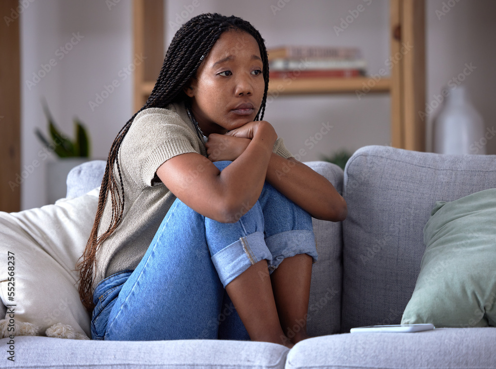 Sad, depression and lonely black woman on sofa with mental health issue, problems and stress ...
