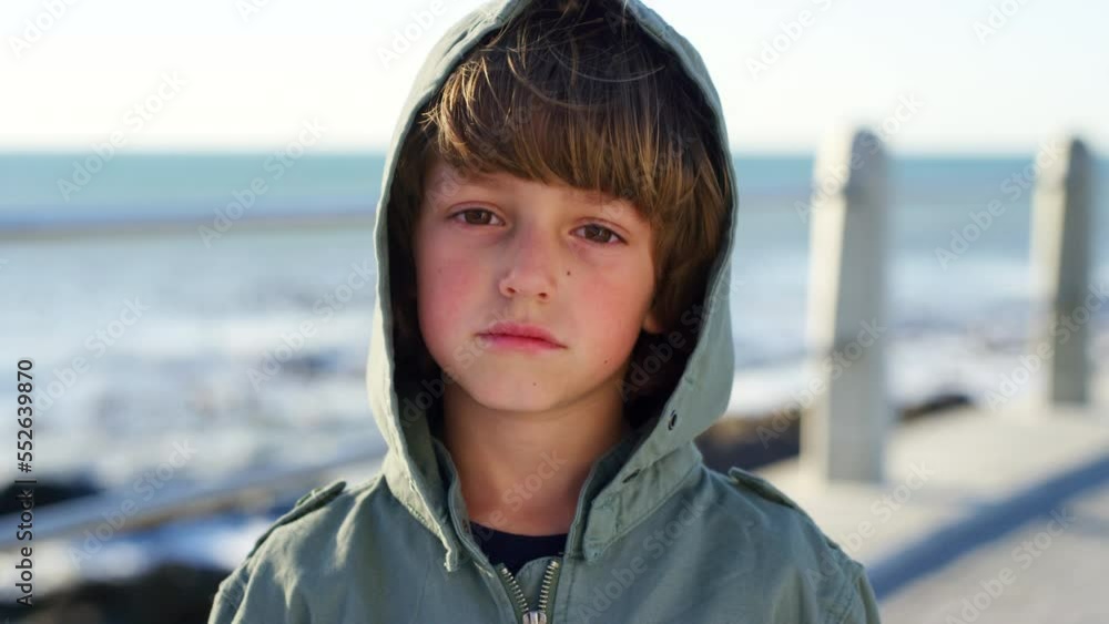 Face of sad, lonely and lost boy at beach promenade looking depressed ...