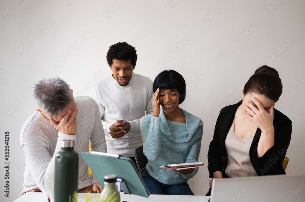 Group of worried and disappointed business people working in office and ...
