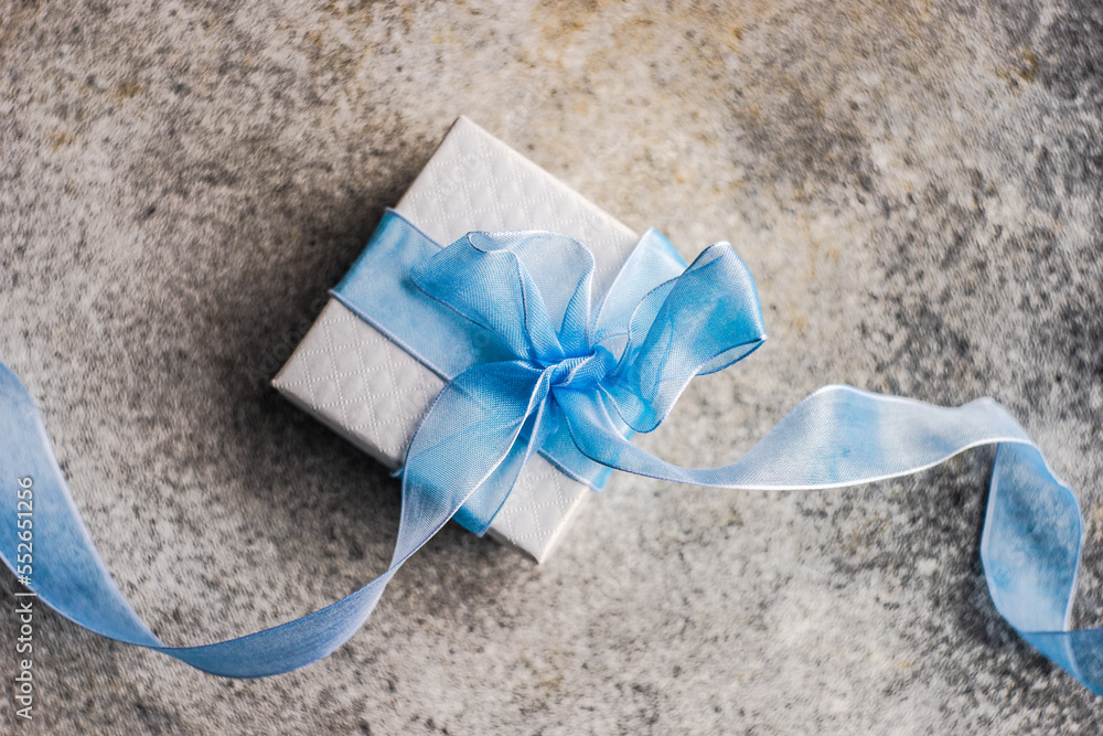 Gift box with light blue ribbon Stock Photo | Adobe Stock