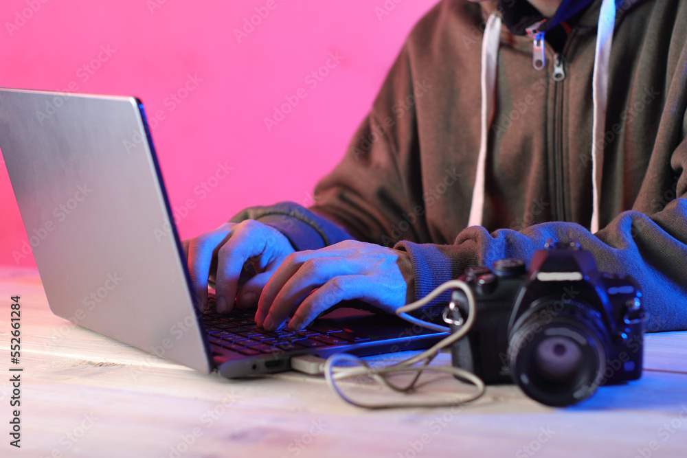 ripping photos from a digital slr camera to a laptop with a cable on a ...