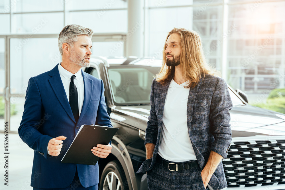 Automotive business, car sale or rental concept. Two different age men ...