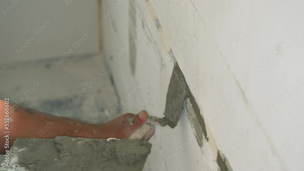 Male construction worker securing electric cables installed in bare ...
