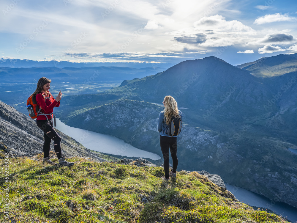 Two women exploring the mountains and wilderness of the Yukon, feeling ...