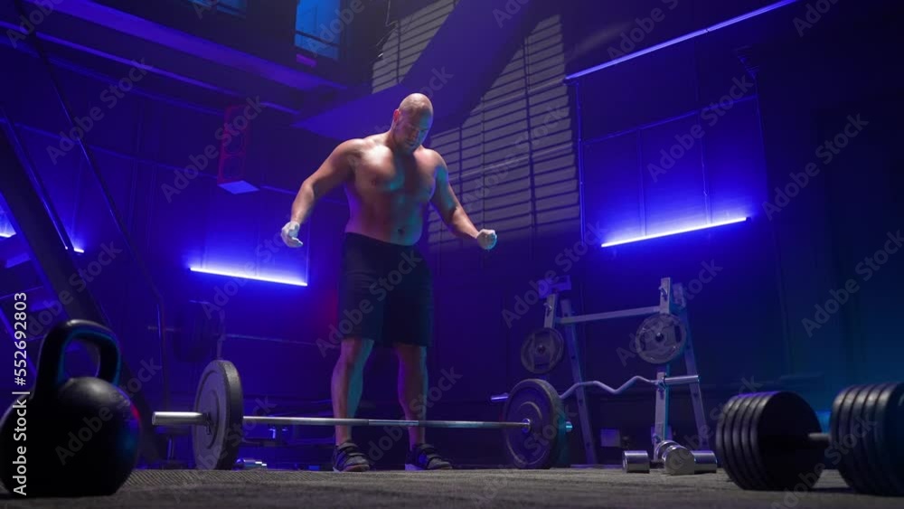 Muscular man with naked torso clapping his hands with white powder and ...