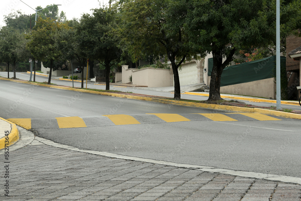 City street with striped concrete speed bump Stock Photo | Adobe Stock