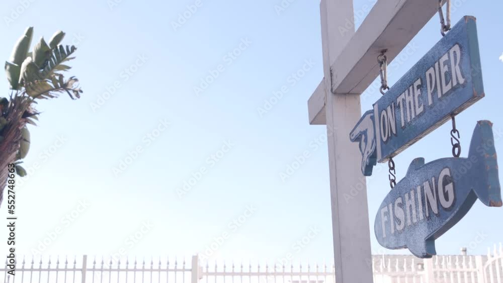 Fishing on pier wooden blue sign, California ocean beach, USA. Coast ...