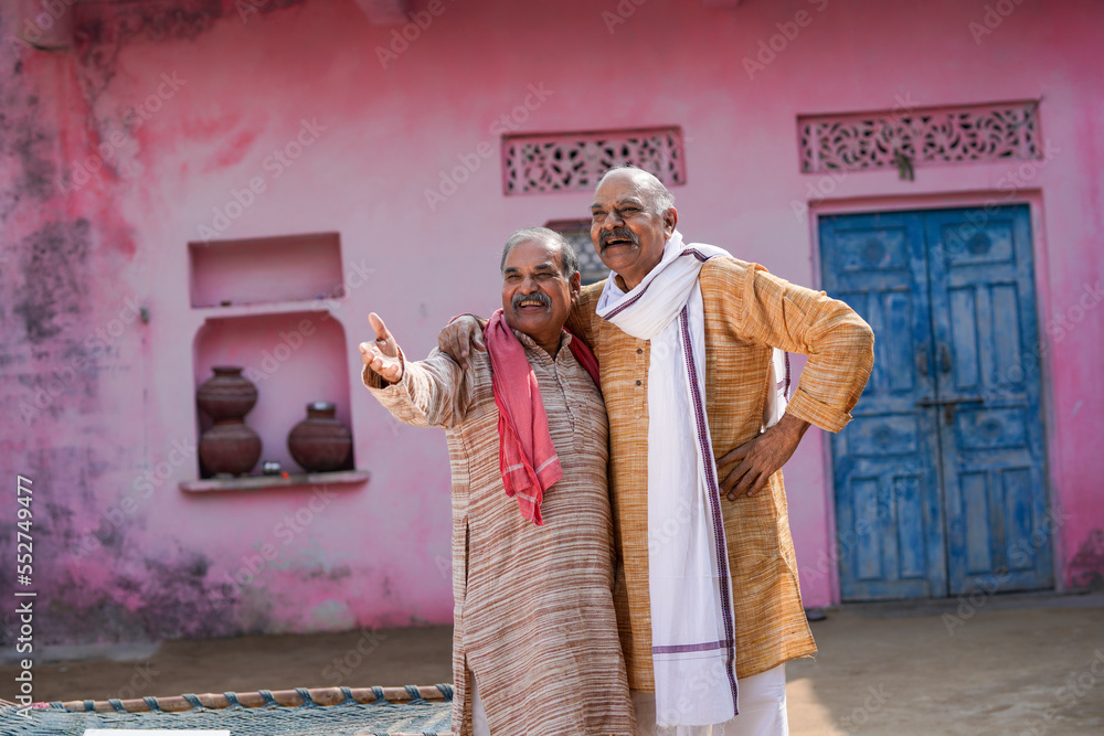 Two old indian villagers giving happy expression out of home. Stock ...