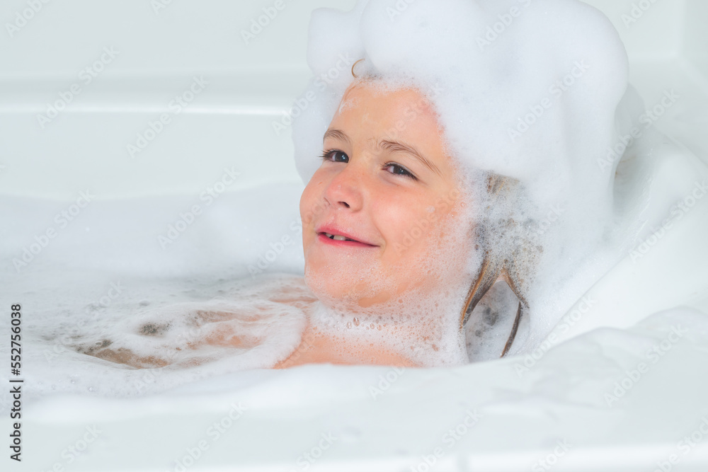 Kids shampoo. Child boy washing with a bubbles in bath. Cute child ...