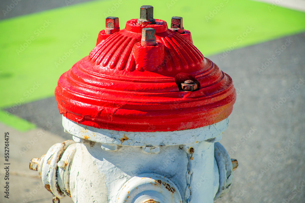Urban fire hydrant with white and red colored paint on the exterior ...