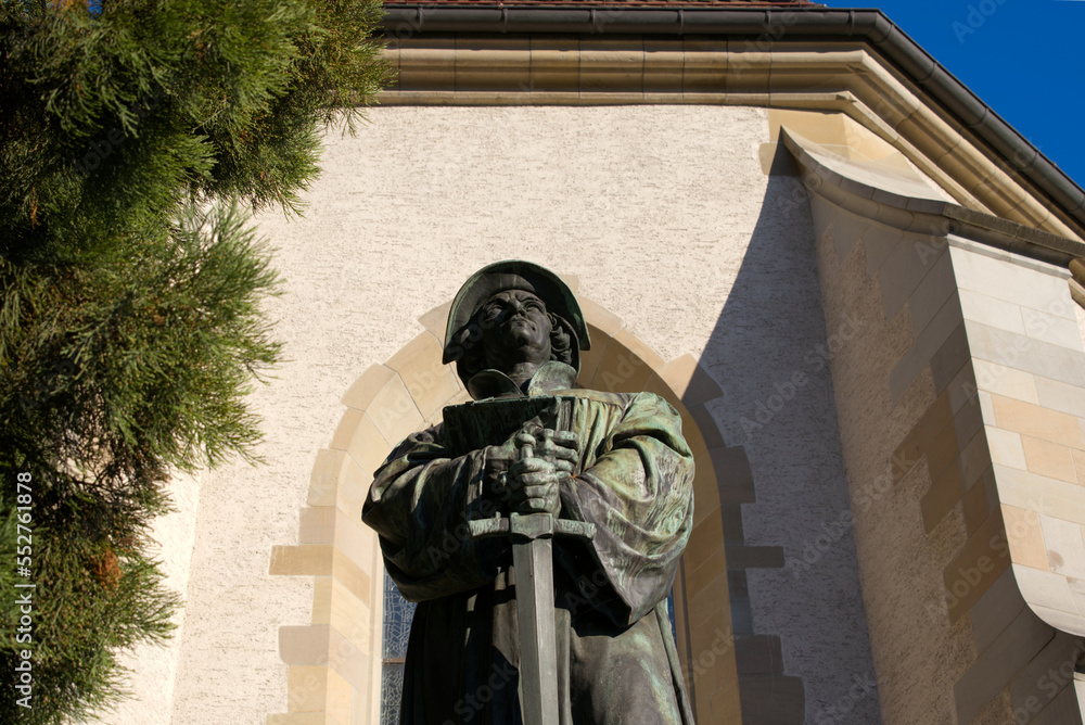 Bronze statue of reformer Ulrich Zwingli at the old town of Zurich on a ...