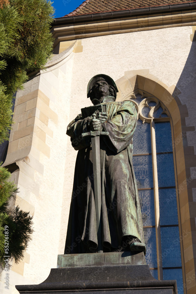 Bronze statue of reformer Ulrich Zwingli at the old town of Zurich on a ...