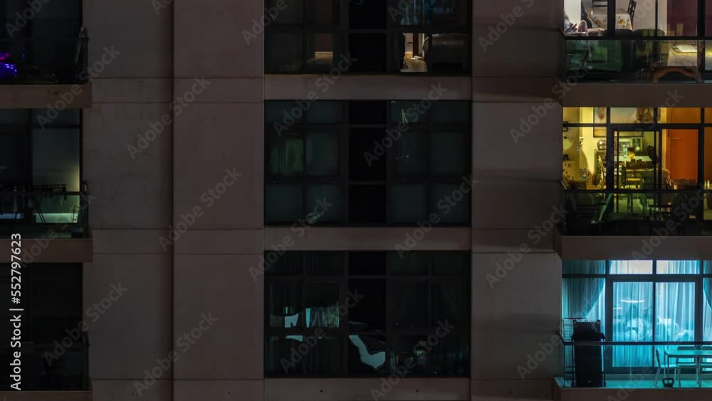 Windows of apartment building at night timelapse, the light from ...