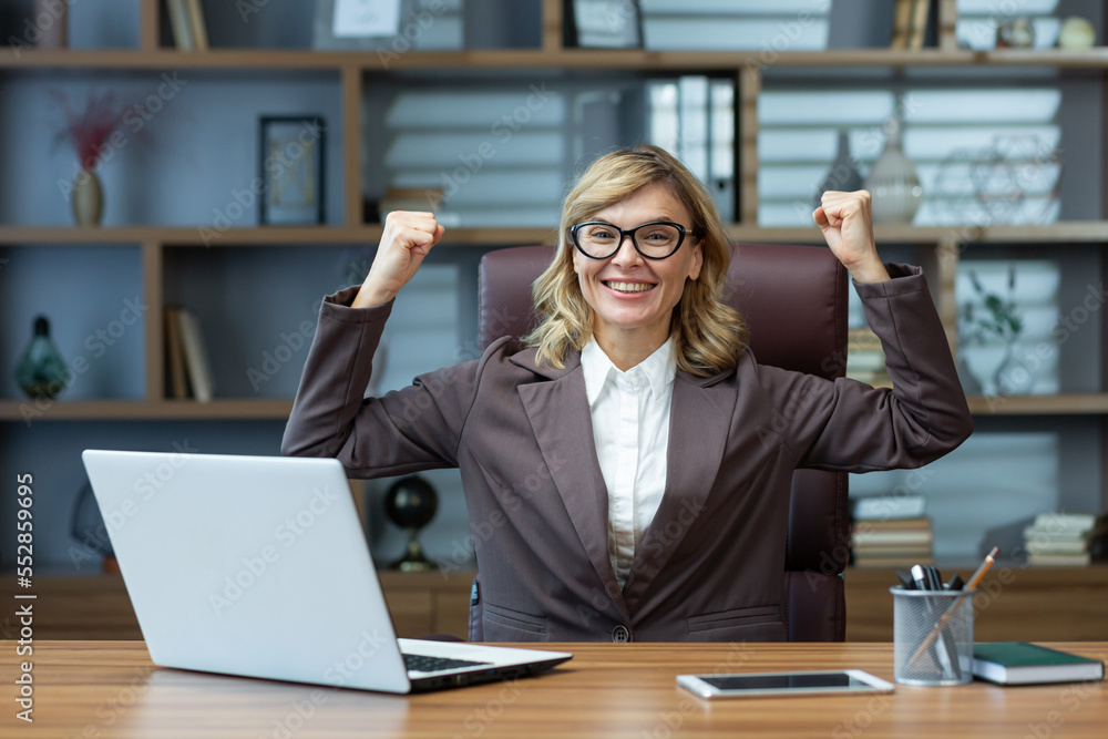 Successful mature businesswoman holding hands up gesture of confidence ...