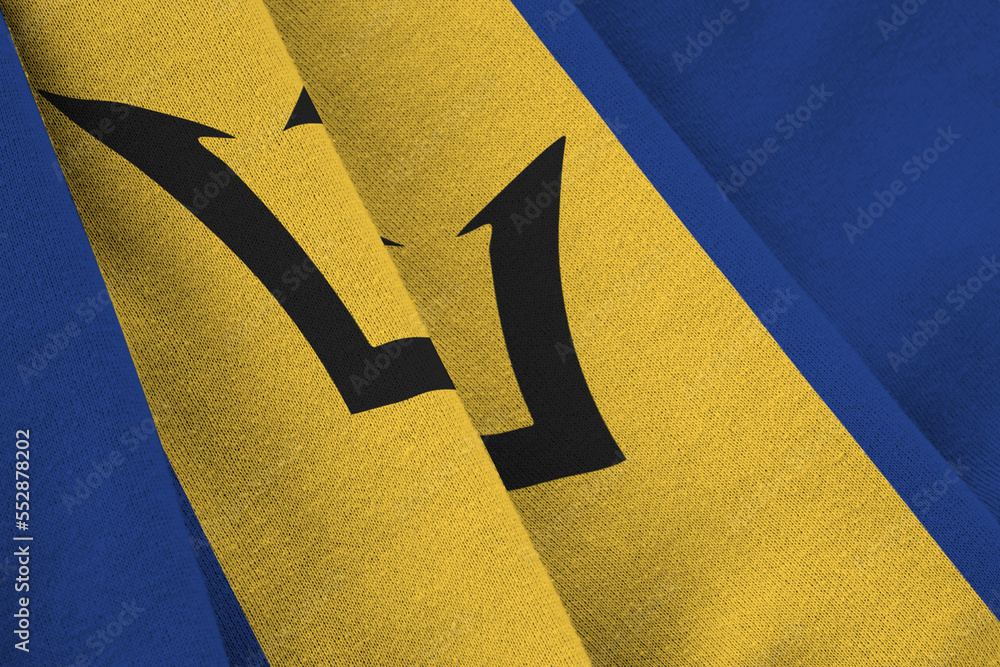 Barbados flag with big folds waving close up under the studio light ...