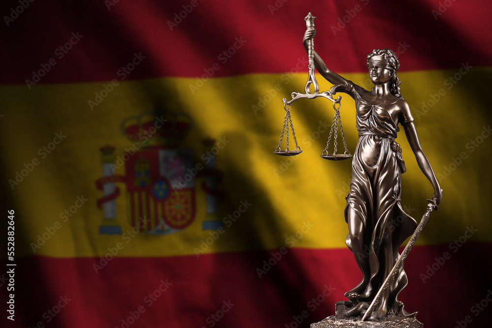 Spain flag with statue of lady justice and judicial scales in dark room ...